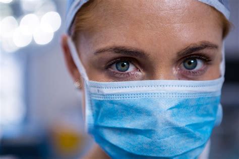 Portrait Of Female Surgeon Wearing Surgical Mask In Operation Theater