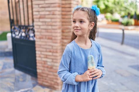 Adorable Caucasian Girl Smiling Confident Eating Ice Cream At Street