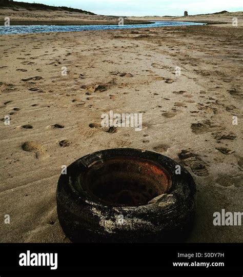 Abandoned Old Useless Tire On Empty Sandy Beach Stock Photo Alamy