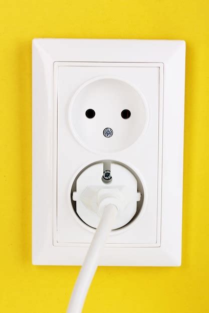 Premium Photo White Electric Socket With Plug On The Wall