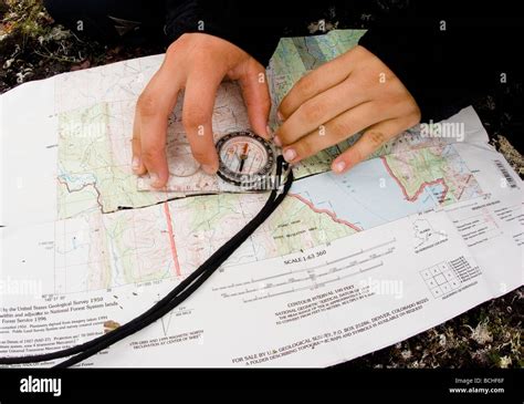 View Of Hands Compass And Map As Backpacker Navigates Resurrection
