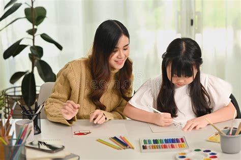 Image Of Mother And Daughter Drawing Together In Bright Living Room