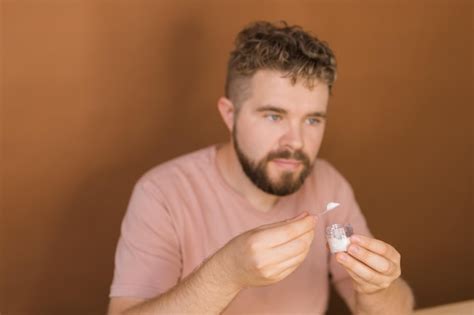 Premium Photo Famous Blogger Cheerful Male Vlogger Showing Cosmetics
