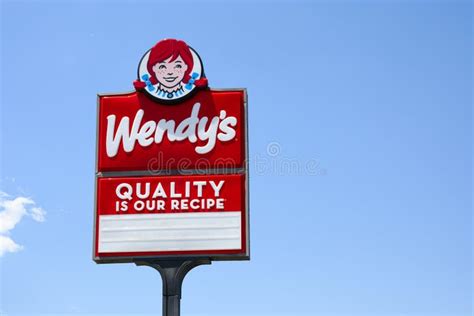 Sign With Logo And Name At Wendy S Fast Food Restaurant With Blue Sky