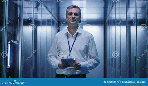 smiling engineer in corridor of data center stock image image of interior indoors 130161579