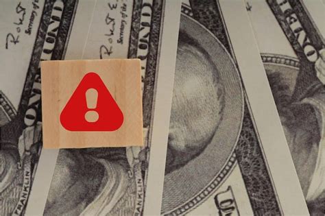 Premium Photo Money Banknotes With A Caution Warning Sign Symbol