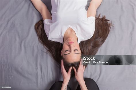 Young Woman Lying While Enjoying The Acupressure Techniques Of Traditional Thai Massage On Her