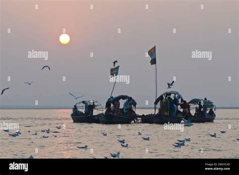 Boats With Pilgrims At Sangam The Confluence Of The Holy Rivers Ganges