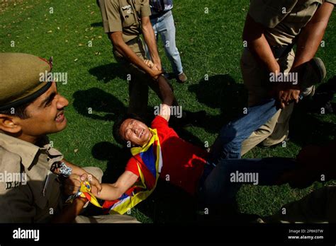 A Tibetan Exile Raises Protest Slogans As He Is Detained By Police
