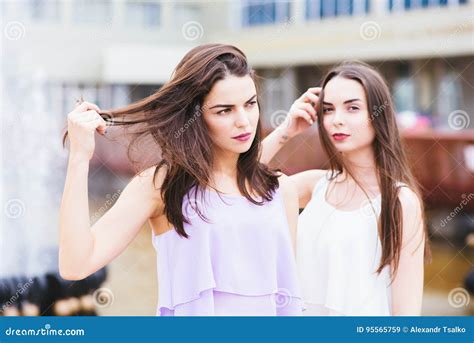 Two Beautiful Girlfriends Pose On The Street Stock Image Image Of