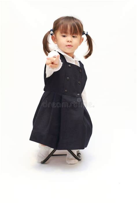 Japanese Girl On The Chair Playing Rock Paper Scissor In Formal Wear