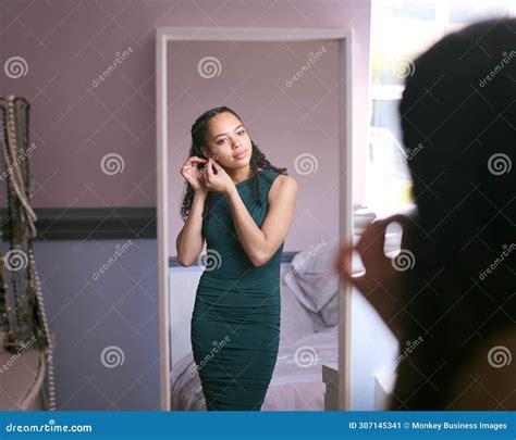 Teenage Girl At Home In Bedroom Getting Ready For Prom Or Night Out
