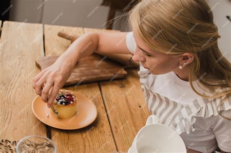 Premium Photo Woman Pastry Chef In Apron Decorates Dessert