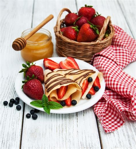 Premium Photo Crepes With Strawberries And Chocolate Sauce