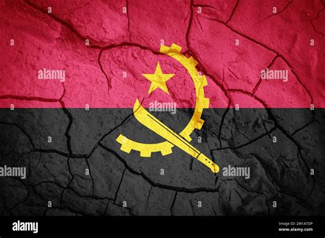 Flag Of Angola Angolan Symbol Flag On The Background Of Dry Cracked Earth Angolan Flag With