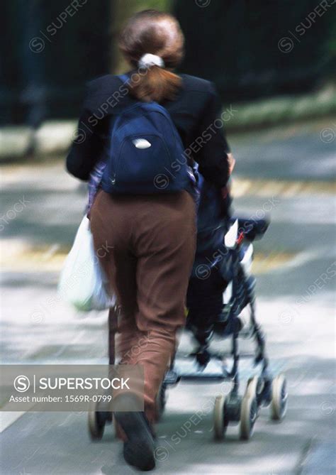 Woman Pushing Stroller Superstock