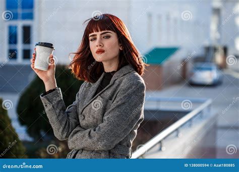 Young Beautiful Caucasian Business Woman On The Street With Coffee