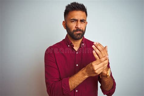 Young Indian Man Wearing Red Elegant Shirt Standing Over Isolated Grey