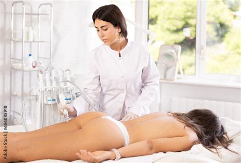 Cosmetologist Performing Hardware Procedure On Woman Buttocks Using Ion Bubble Pen Of Hydrogen