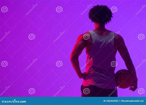 Image Of Rear View Of Biracial Basketball Player With Basketball On