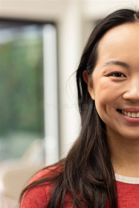 Smiling Young Asian Woman With Long Hair Wearing Red Shirt Looking At