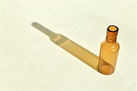 Premium Photo High Angle View Of Glass Bottle On Table