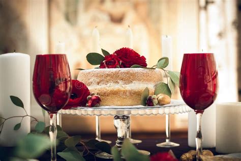 A Banquet Table In A Restaurant With Red Wine Glasses A Stylish Cake