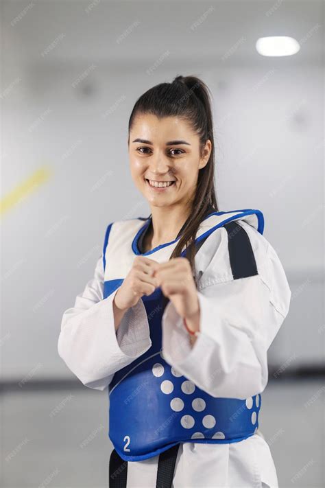 Premium Photo Portrait Of A Happy Taekwondo Girl In Dobok In Strike
