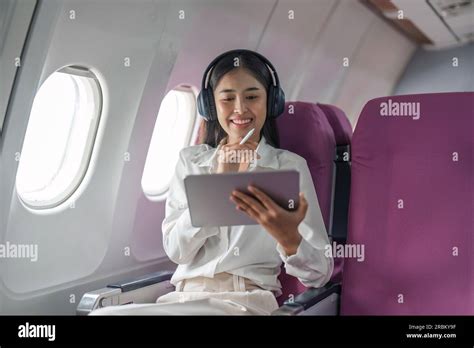 Plane Passenger Business Woman Working In Airplane Cabin During Flight With In Flight Wifi