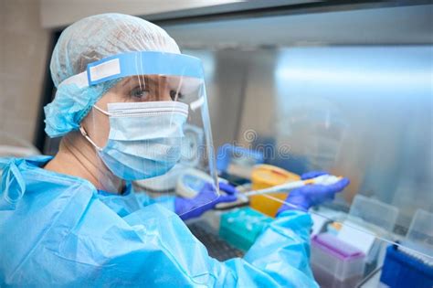 Laboratory Assistant Holds A Laboratory Pipette Dispenser In Her Hands
