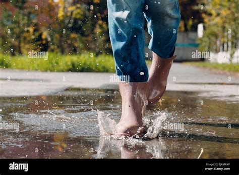 Woman Wearing Rain Rubber Boots Walking Running And Jumping Into Puddle