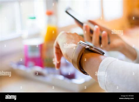 Female With Mobile Phone Connected To A Smartwatch Stock Photo Alamy