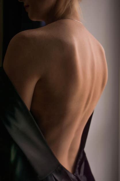 Premium Photo Mid Adult Woman Undressing Against Gray Background