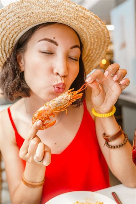 Asian Woman In Hat Eating Local Spanish Cuisine Grilled Seafood Stock