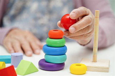 Elderly Asian Woman Engaging In Puzzle Games For Brain Training To