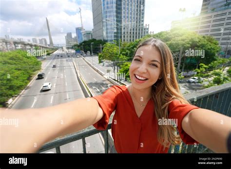 Tourism In Sao Paulo Beautiful Smiling Girl Takes Self Portrait With Ponte Estaiada Bridge In