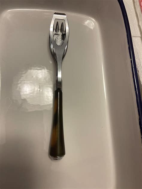 This Strange Looking Olive Serverfork Attached To What Is Looking Like