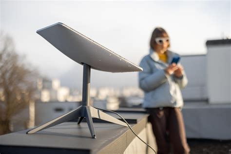 Premium Photo Woman With Phone Uses Starlink Satellite Internet On Roof