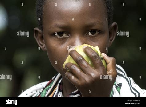 Digo Girl Eating A Mango Kenya Stock Photo Alamy