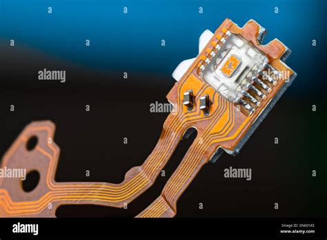 Closeup Of Optical Sensor On Electronic Printed Circuit Board Or Flex Ribbon Cables On Dark Blue