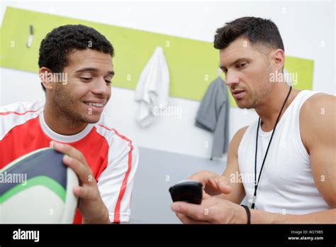 Rugby Coach And Player In Locker Room Stock Photo Alamy