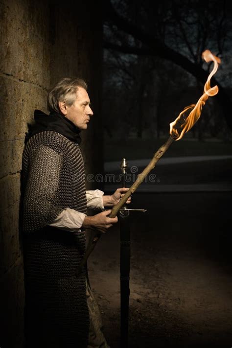 Armed Man In Chain Armor With Sword Serving As Guard At Night With