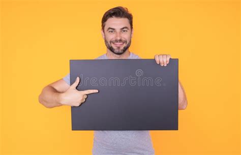 Guy With Blank Banner Ad Isolated On Studio Background Man Holding Empty Blank Poster Showing
