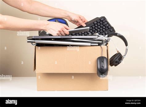 Female Hands Put Tablet Computer And Keyboard In Box Full Old Used Computers And Gadget Devices