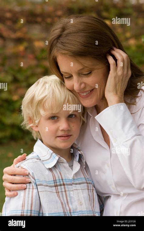 Happy Mother Hugging Her Son Outside Stock Photo Alamy