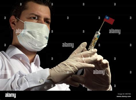 Young Man As A Doctor Gives A Medical Injection To Myanmar Flag On A Black Background Stock