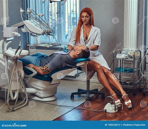 A Hot Redhead Dentist Woman Taking Care Of Her Patient Stock Image Image Of Medicine