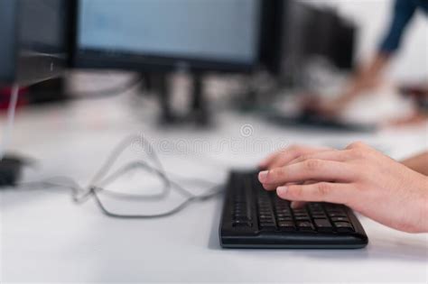 close up programmer man hand typing on keyboard at desktop pc to input code language into