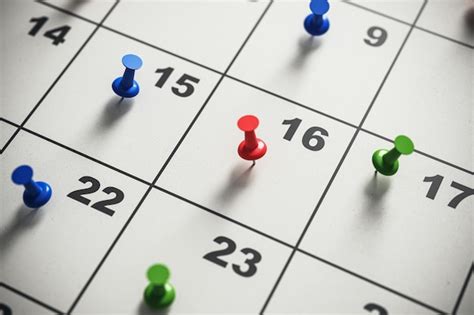 premium photo calendar page with assorted colored pins marking