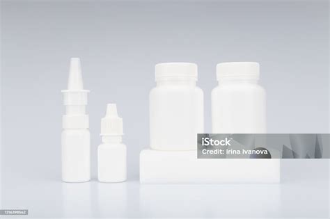 Semprotan Hidung Tetes Mata Dan Dua Botol Obat Di Podium Dengan Latar